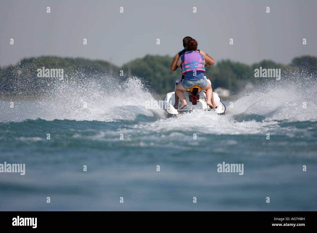 Two people riding a jet ski Stock Photo - Alamy