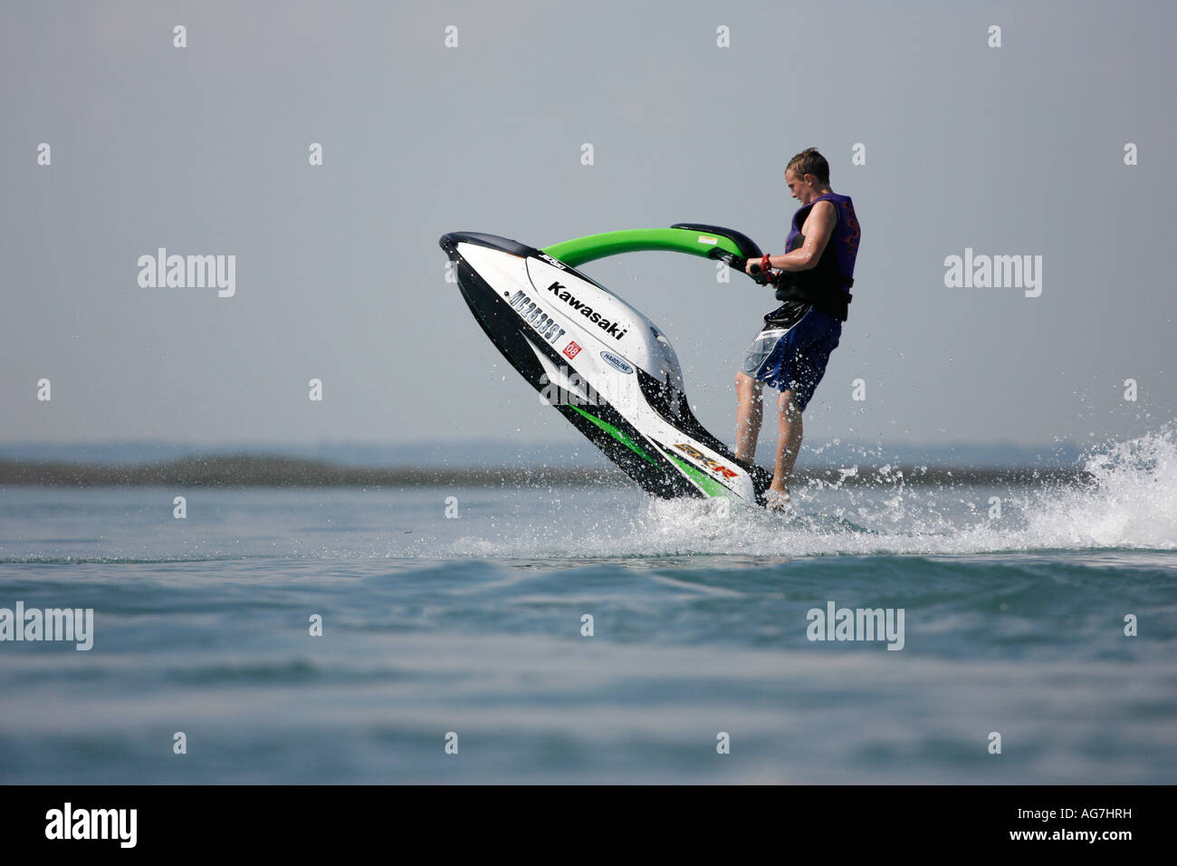 Young man riding a jet ski Stock Photo - Alamy
