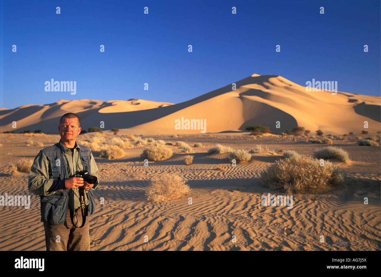 Niger near Agadez Photographer Frans Lemmens standing on sand dunes in ...