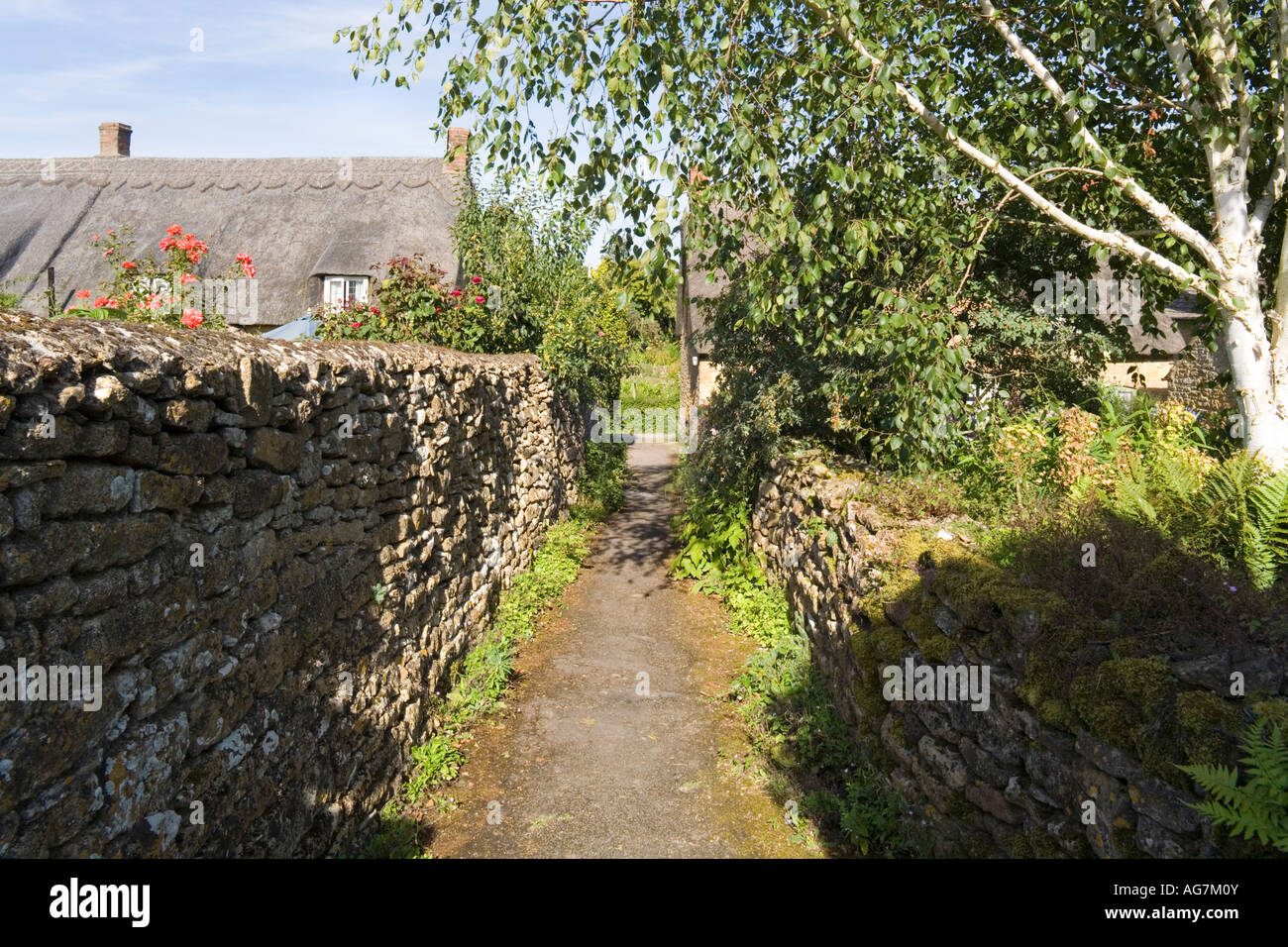 The pathway to the church in the Cotswold village of Ebrington ...