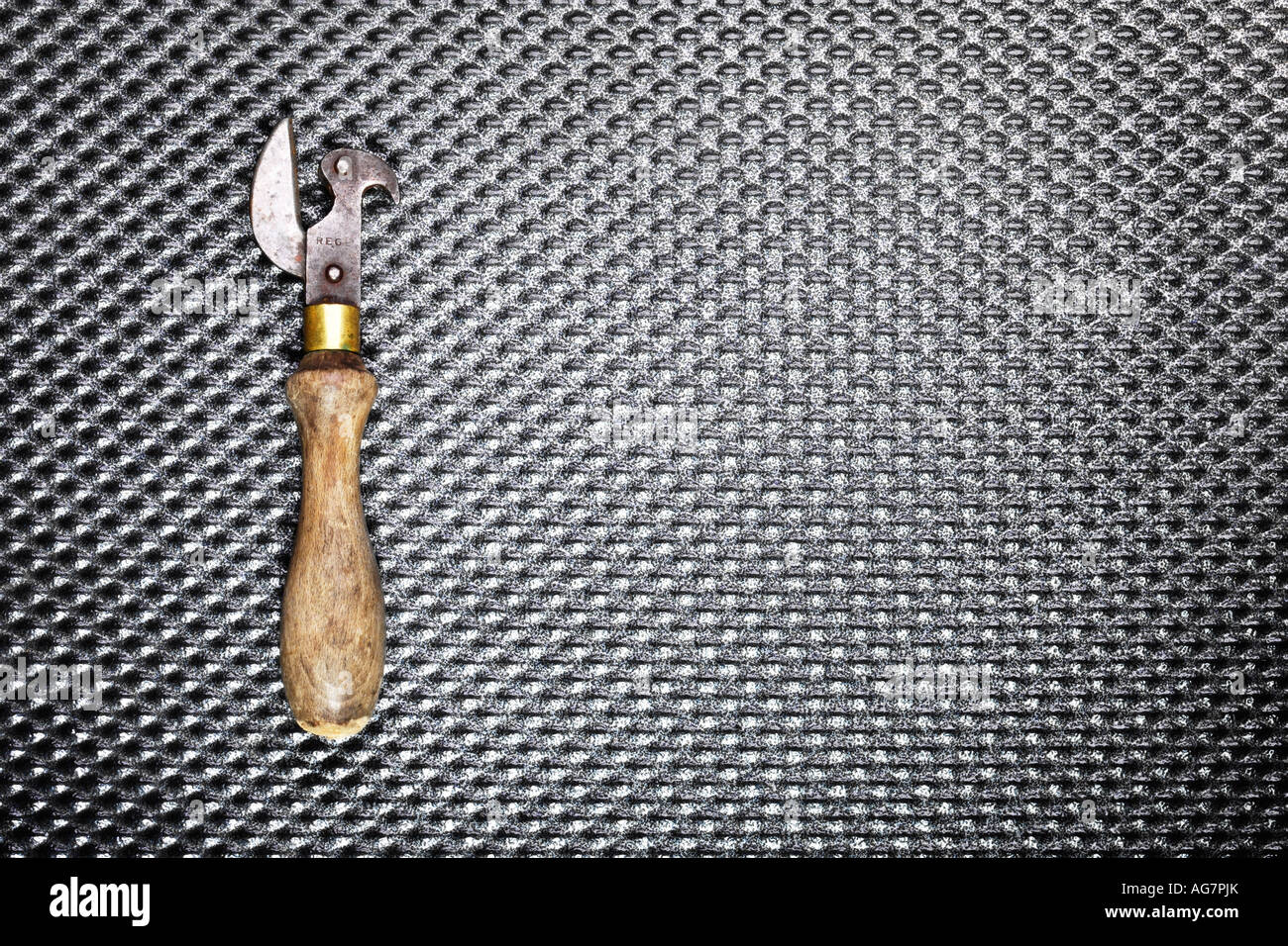 Old style tin opener on metal background landscape format Stock Photo ...