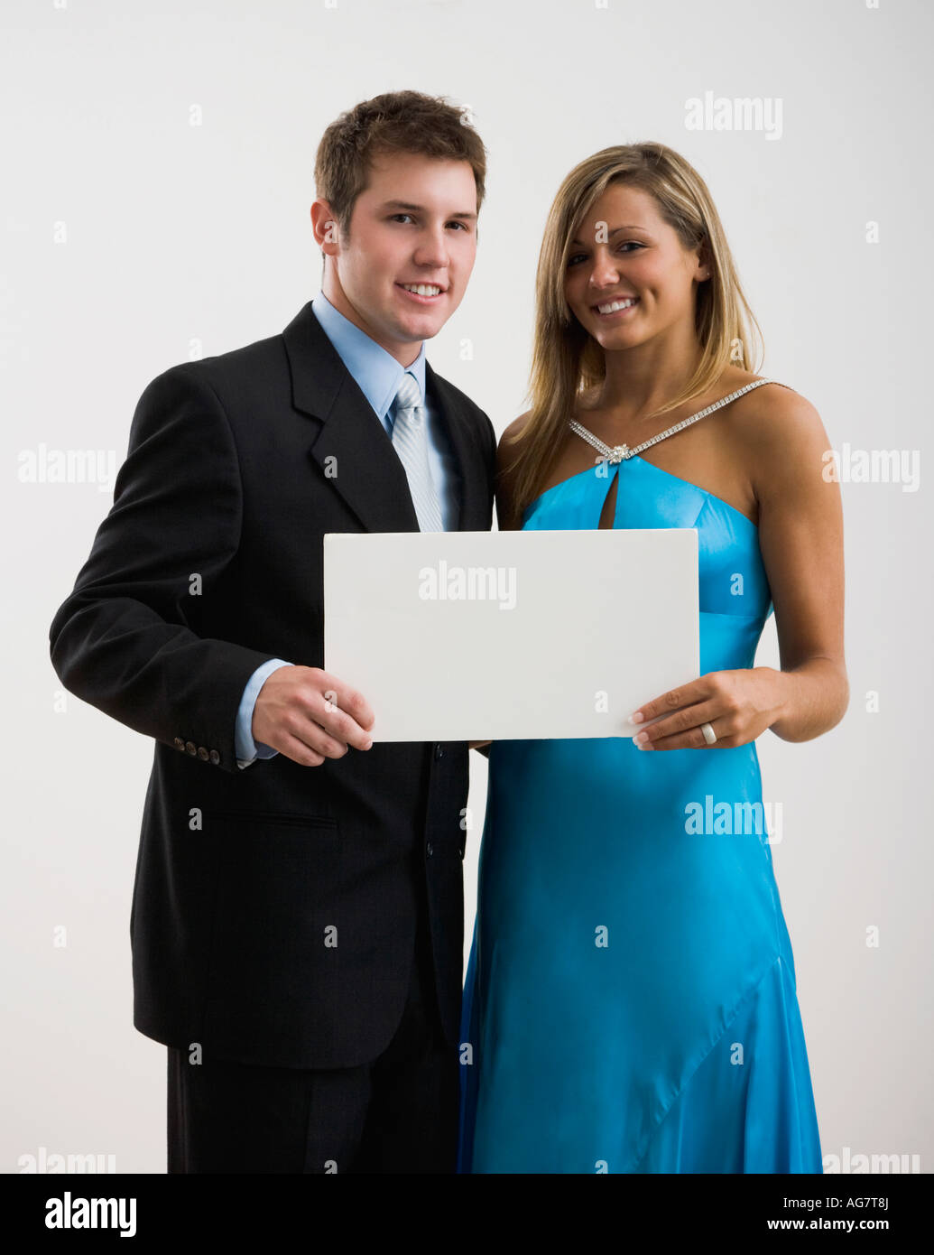 Couple holding sign Stock Photo - Alamy