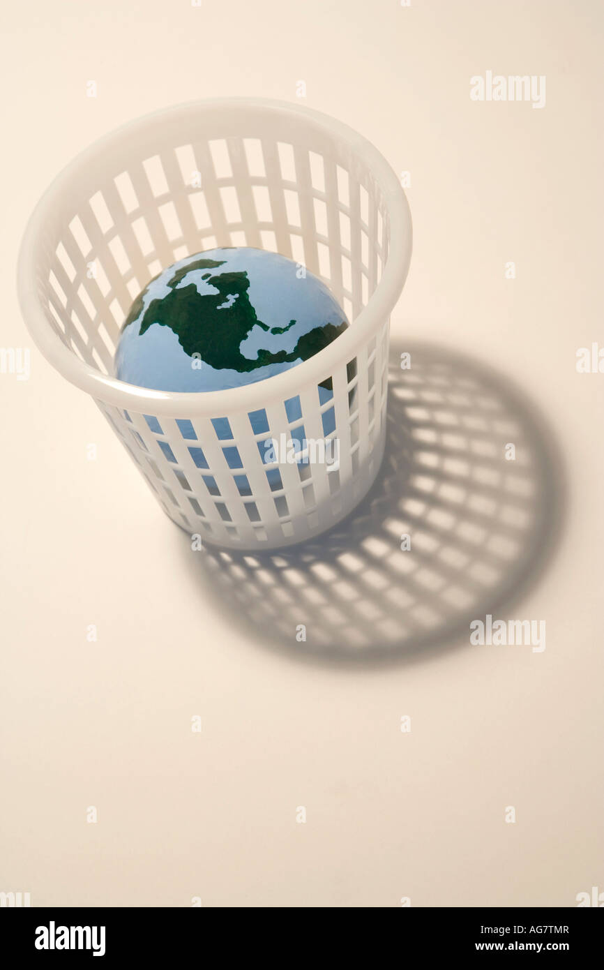 Globe in a garbage bin Stock Photo - Alamy
