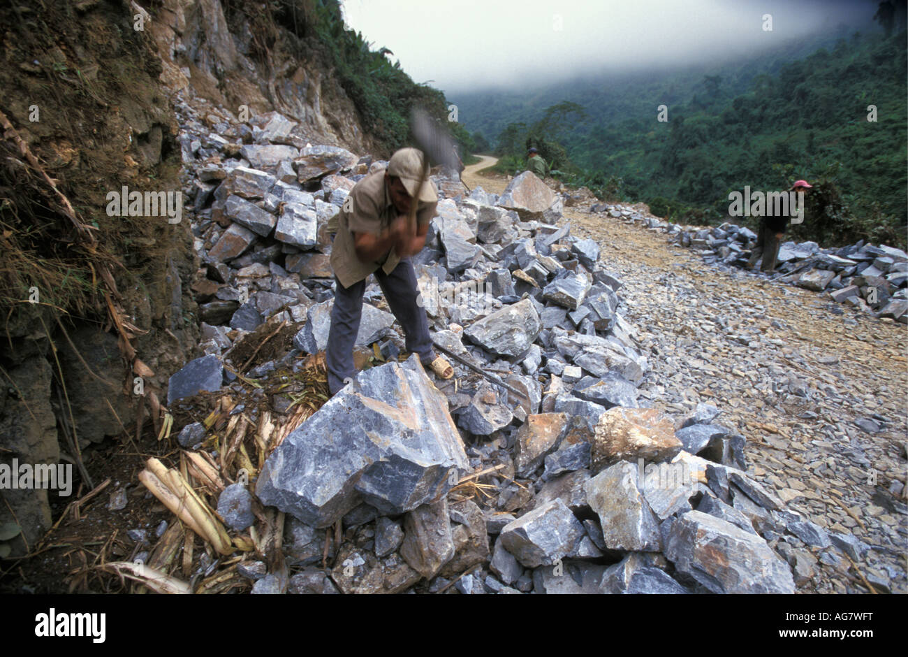 Vietnam Lai Chau Man breaking stones with hammer for road construction ...