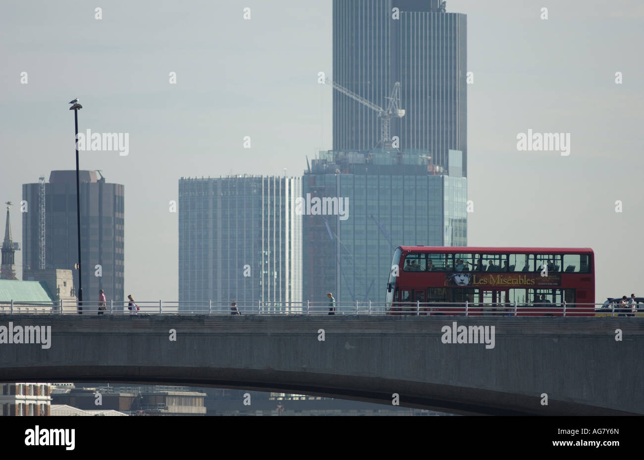 Red double deck london bus crossing Waterloo Bridge with the Ccity of ...