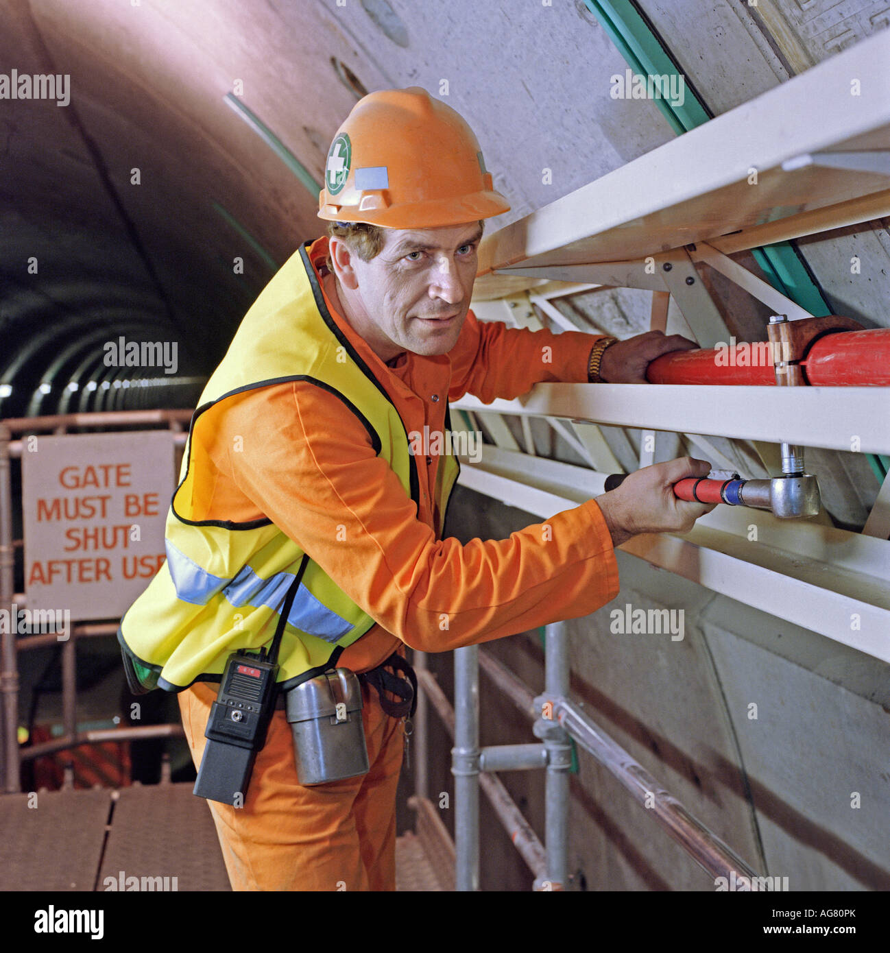 Channel Tunnel engineer installing a 21KV power cable into a rail ...