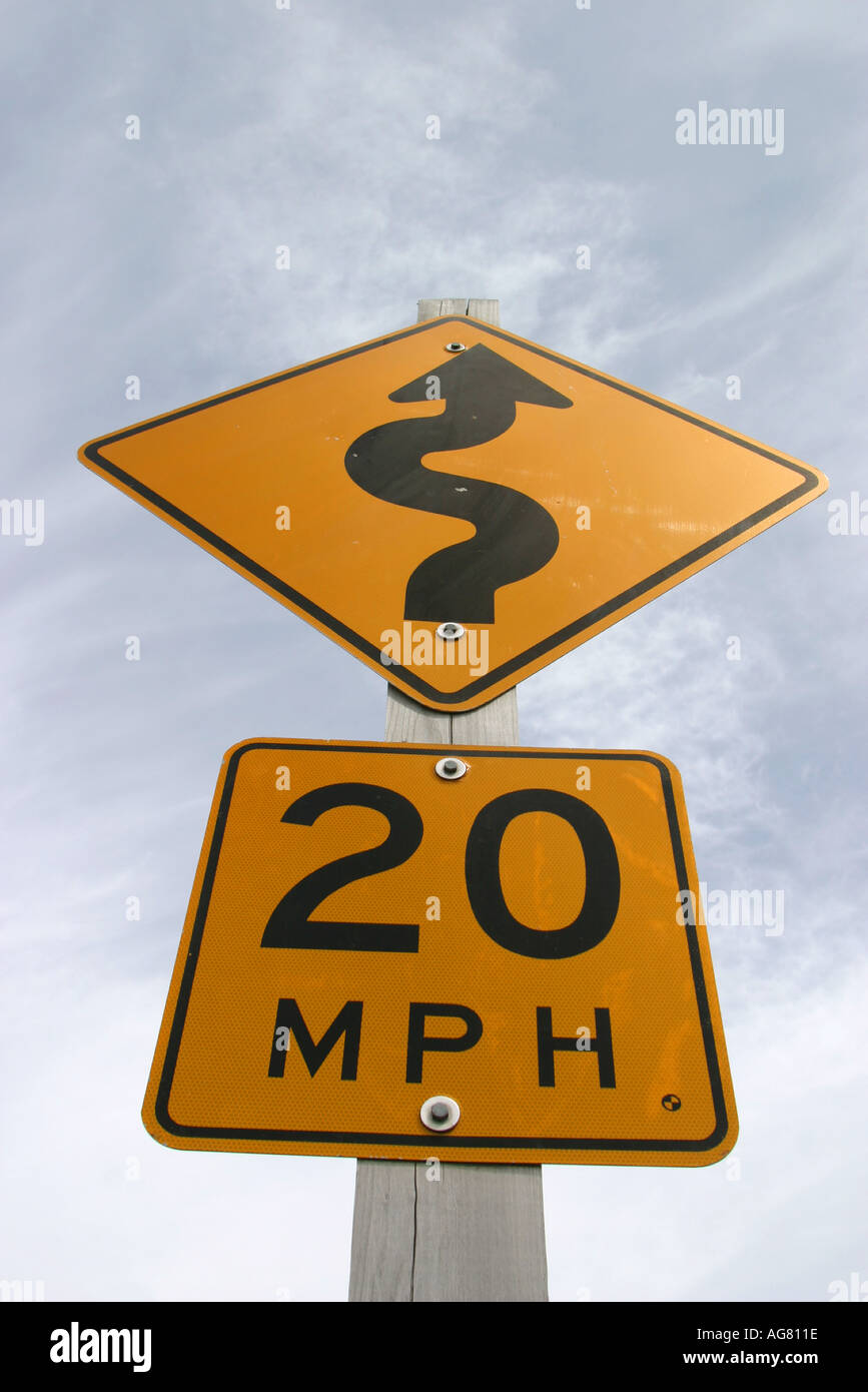 A curved and windy roads and speed limit sign along a highway in rural ...