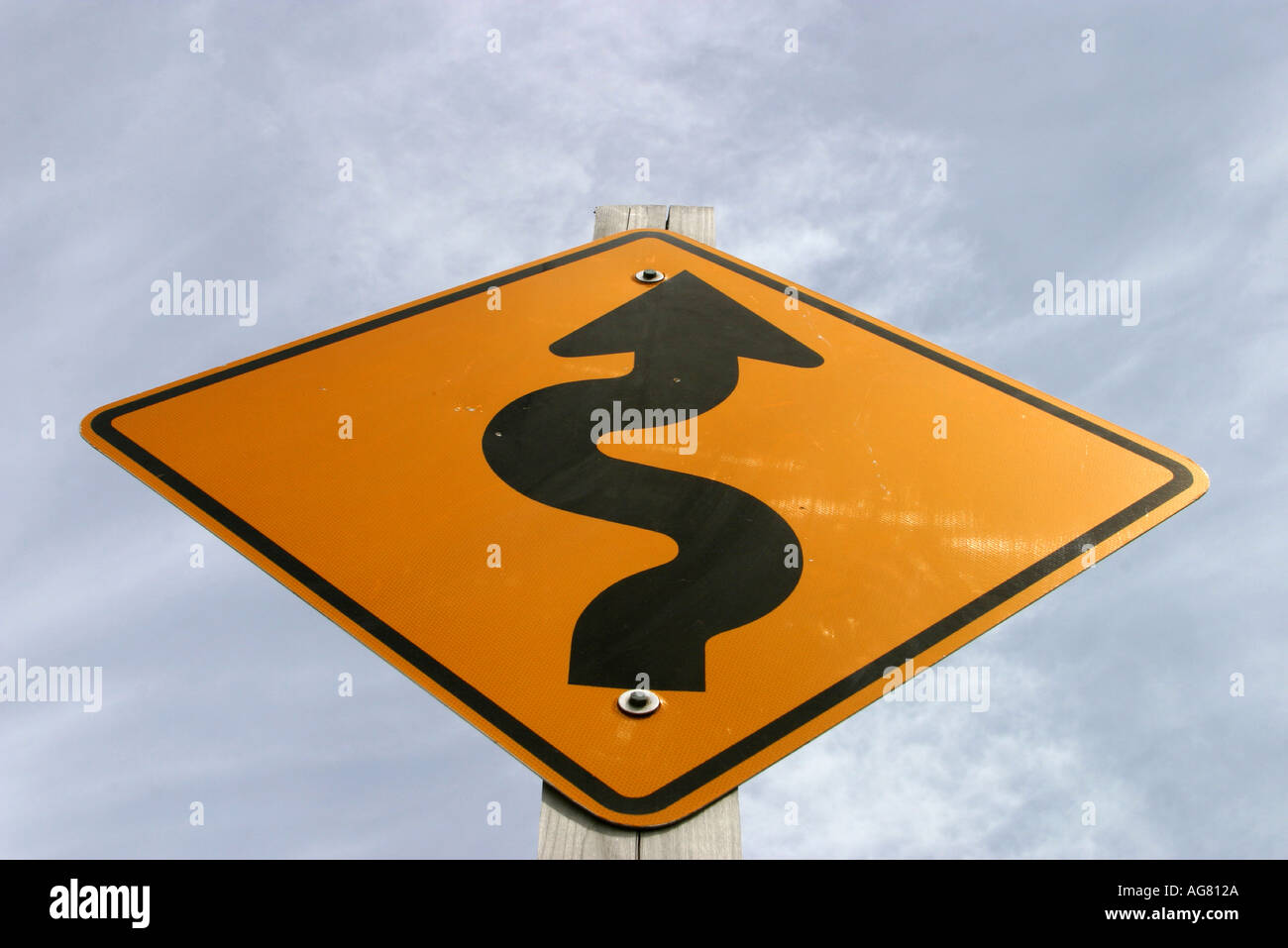 A curved and windy roads sign along a highway in rural Central oregon ...