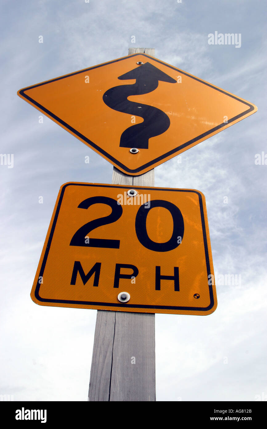 A curved and windy roads and speed limit sign along a highway in rural ...