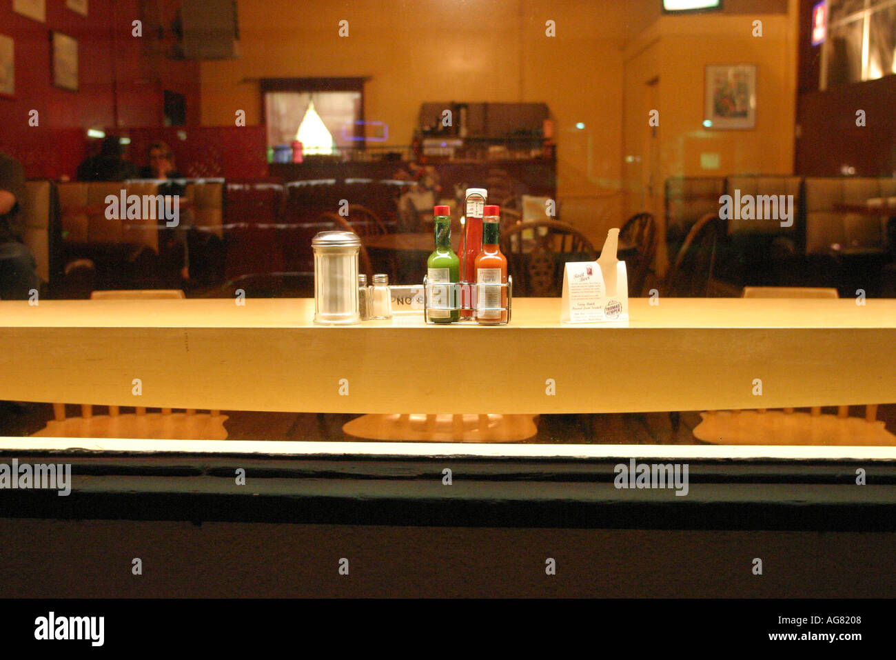 Condiments like ketchup and mustard seen through a diner window in ...