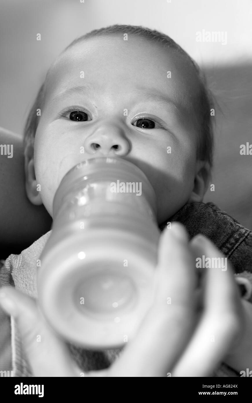 Baby being fed by bottle Stock Photo - Alamy