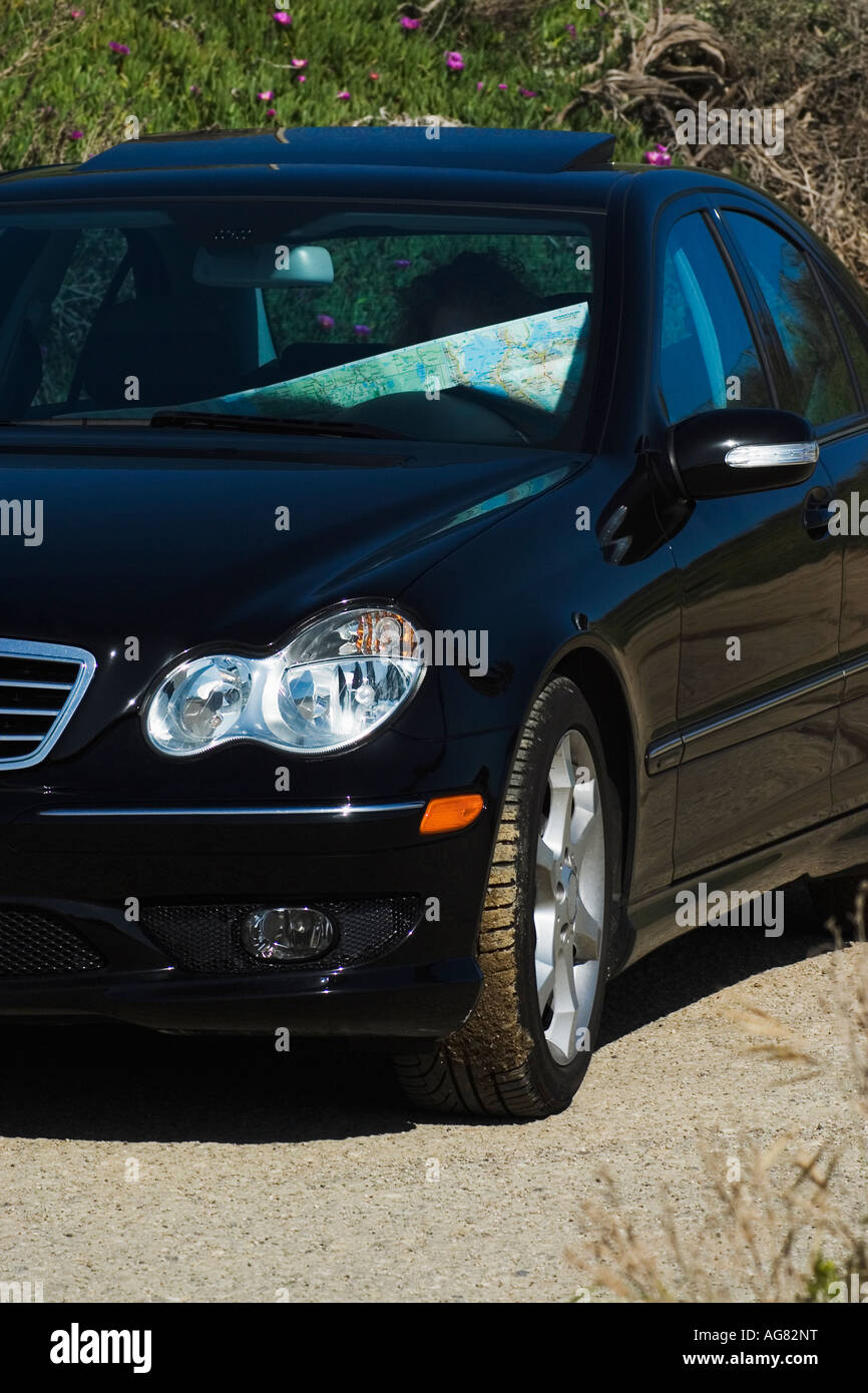 Woman reading map in car Stock Photo - Alamy