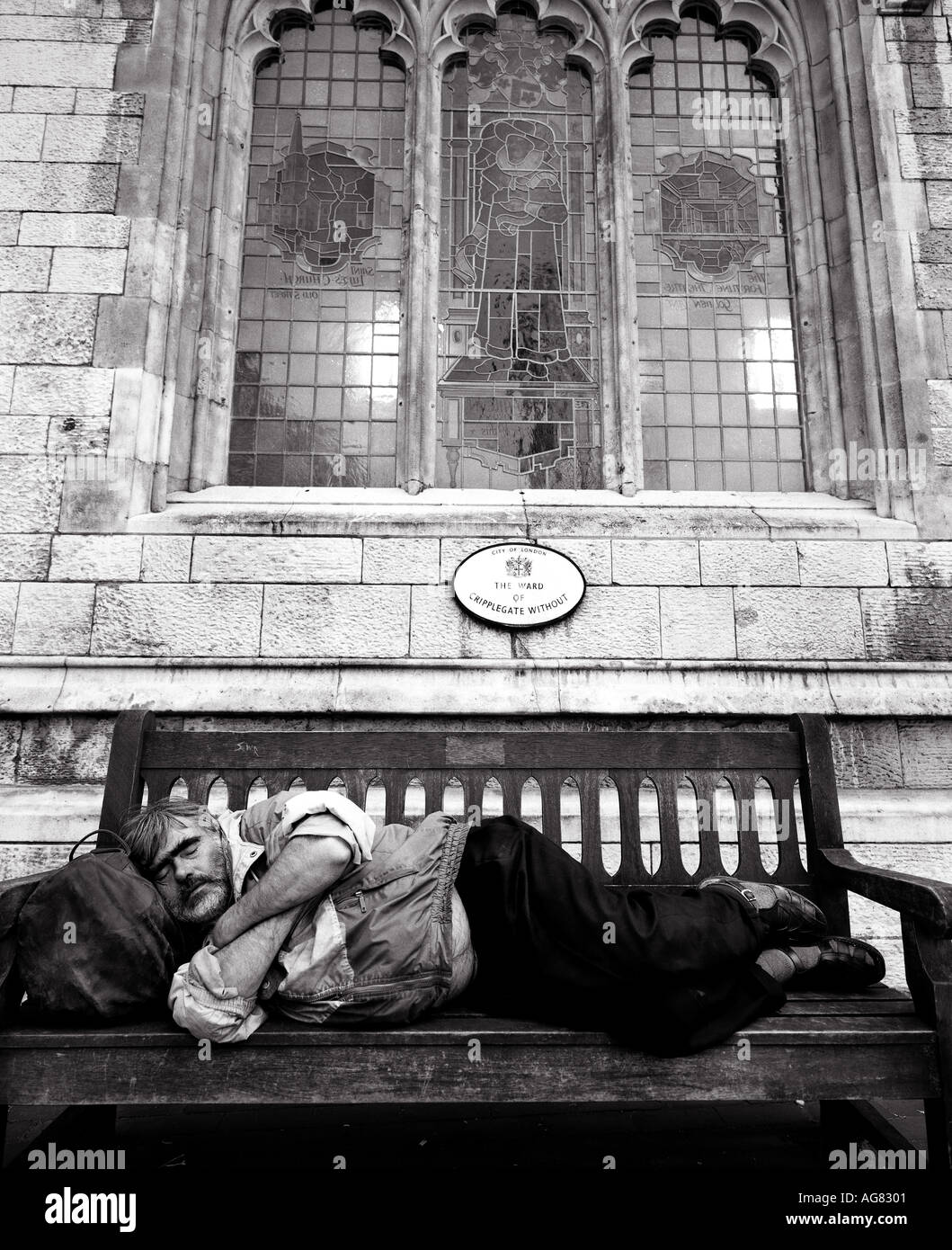 Homeless man sleeping on bench hi-res stock photography and images - Alamy