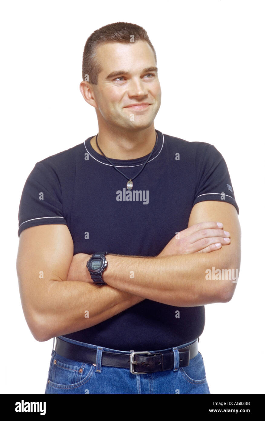 Portrait of a muscular sporty man with his strong arms crossed and ...