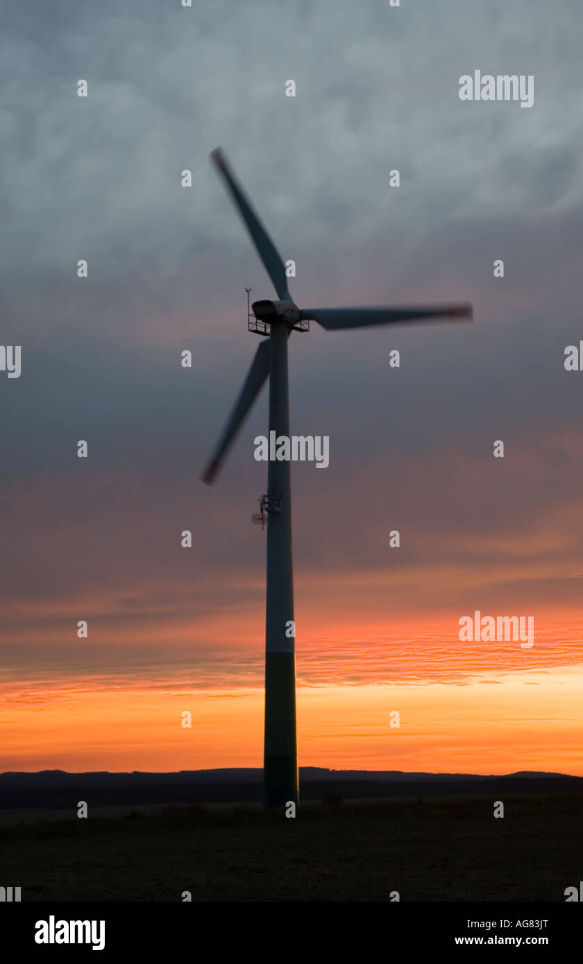 A wind mill shot with slow shutter speed against a beautiful sunset ...