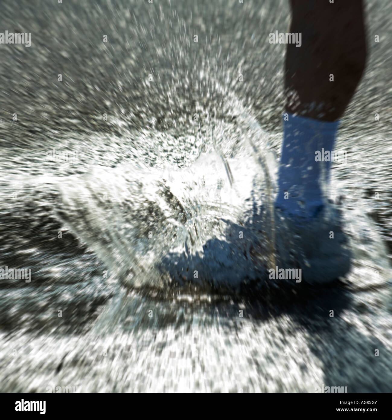 closeup running shoe hitting water puddle Stock Photo - Alamy