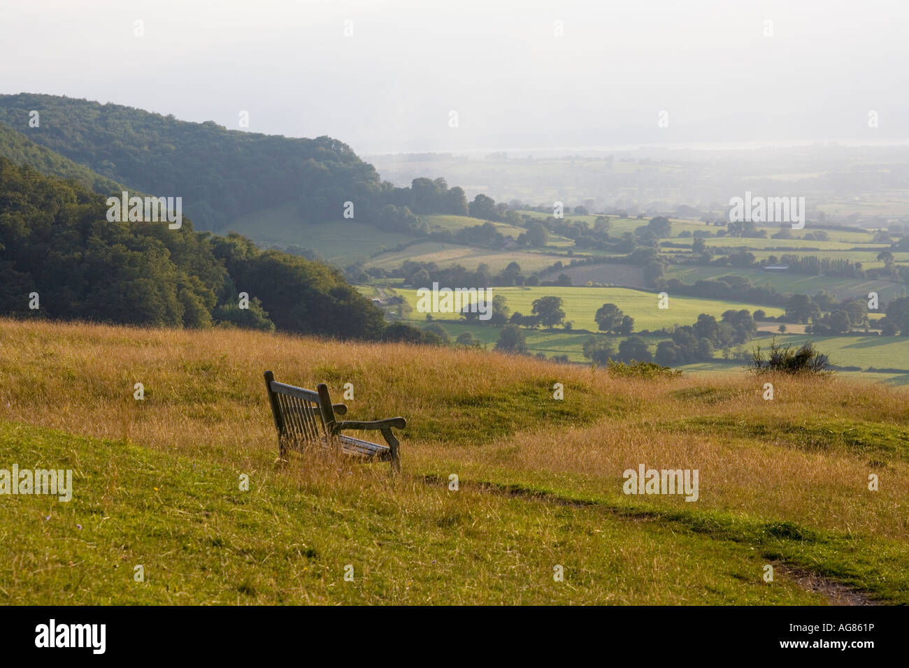 A seat on the Cotswold scarp at Selsley Common with a view towards Pen ...