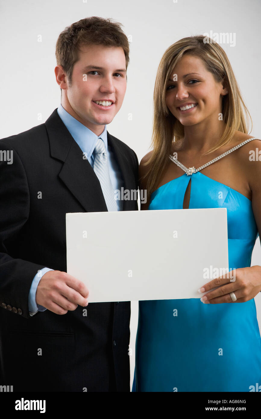 Couple holding sign Stock Photo - Alamy