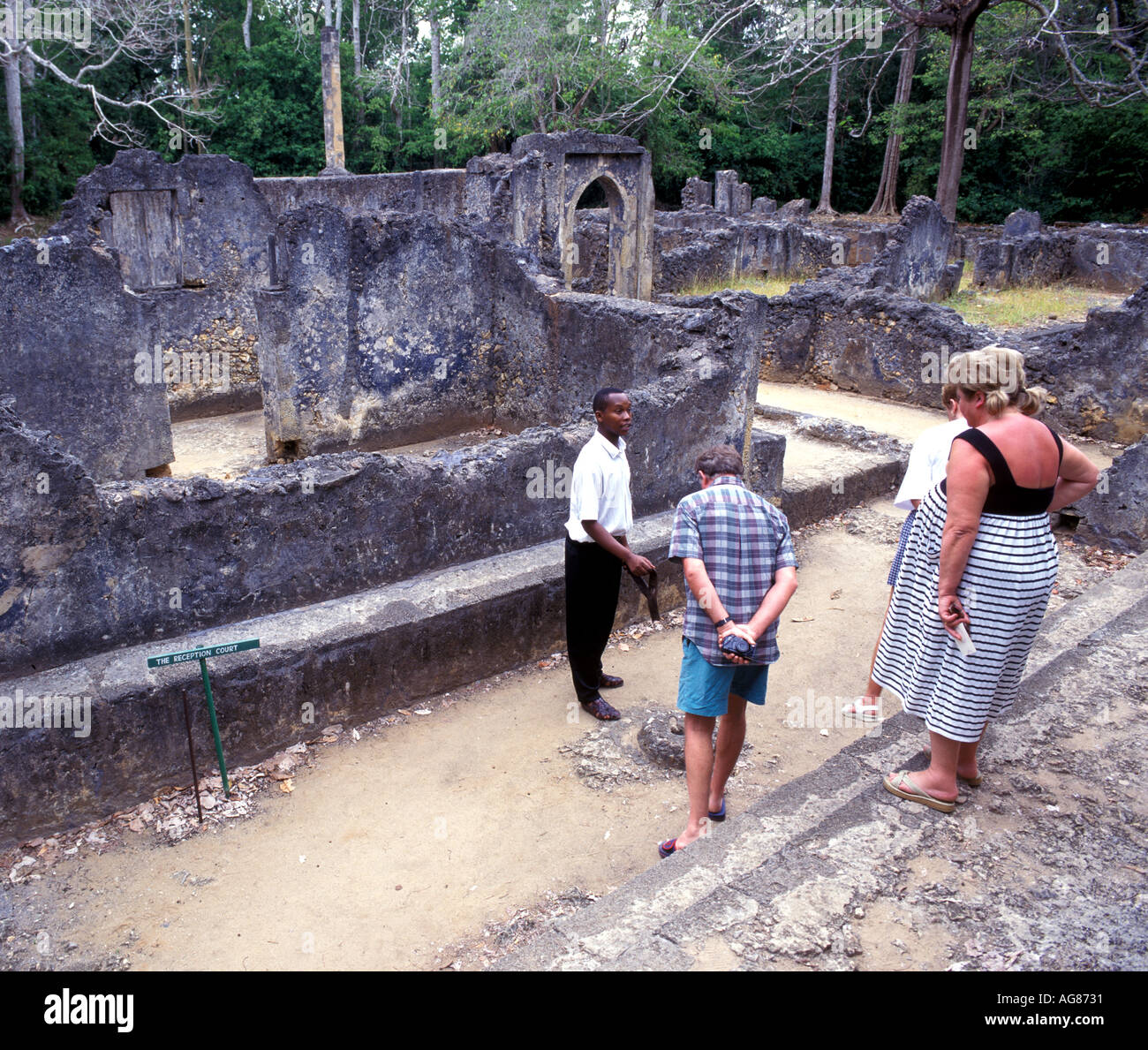 Tourists and guide at the ruins at Gedi in Kenya East Africa Stock ...