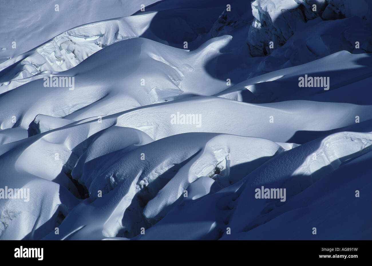 Crevasses covered in fresh snow in the Alps, on a sky route near the ...