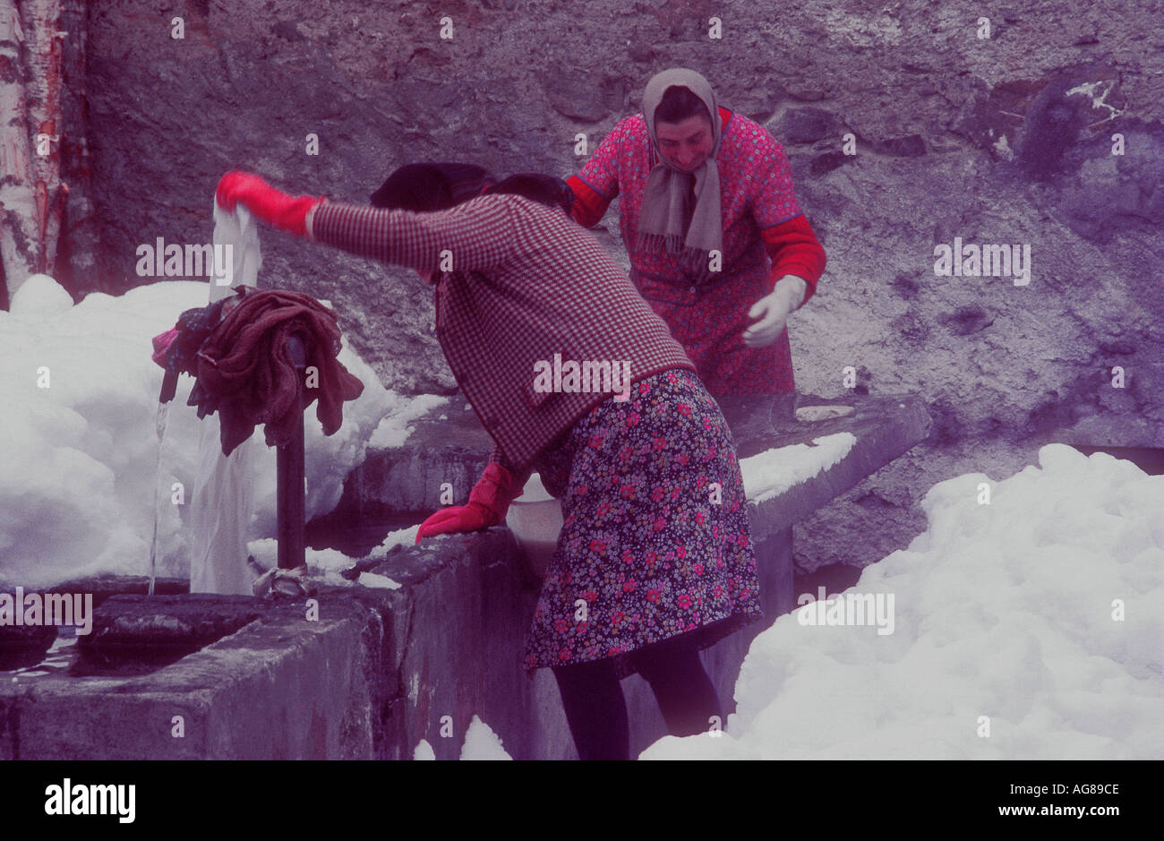 Women washing clothes outdoors at a public washing place in the ...