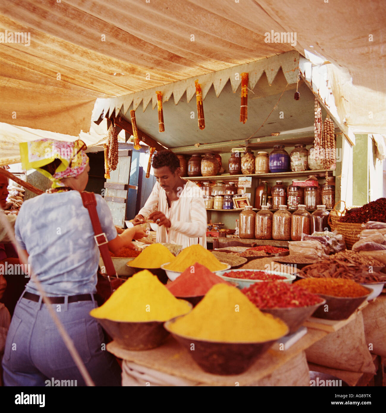 A tourist buying spices at a colourful spice stall in Aswan Egypt Stock ...