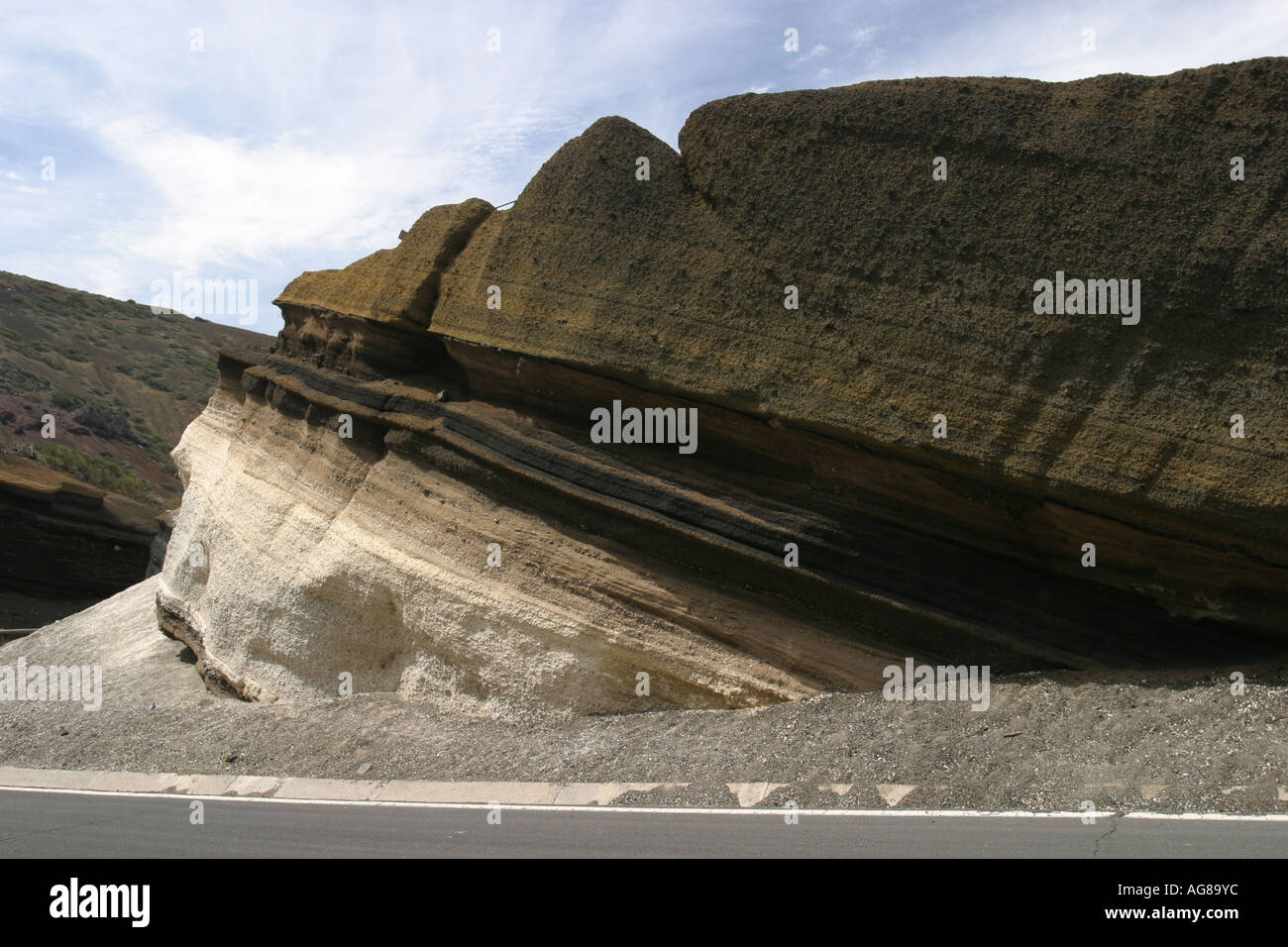 The volcanic rock outcrop called "La Tarta" shows different layers of material of the same ...