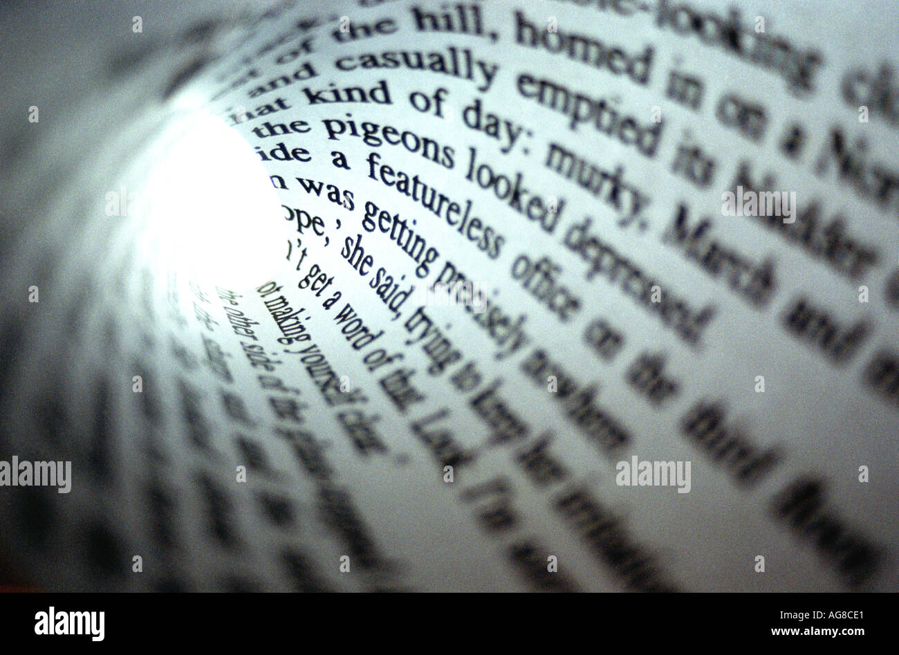 Rolled up text, looking through the words Stock Photo - Alamy