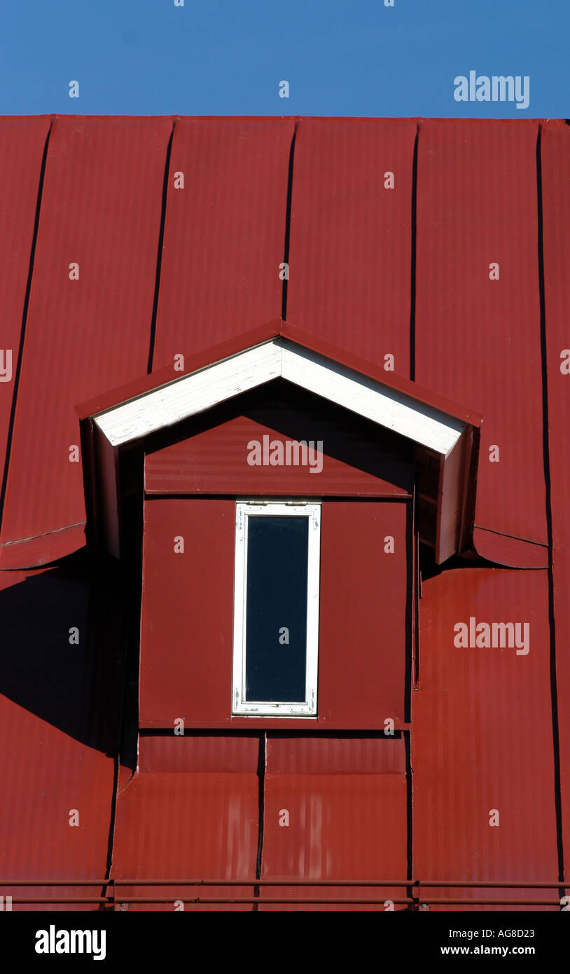 Small attic window at bright red tin roof Stock Photo - Alamy