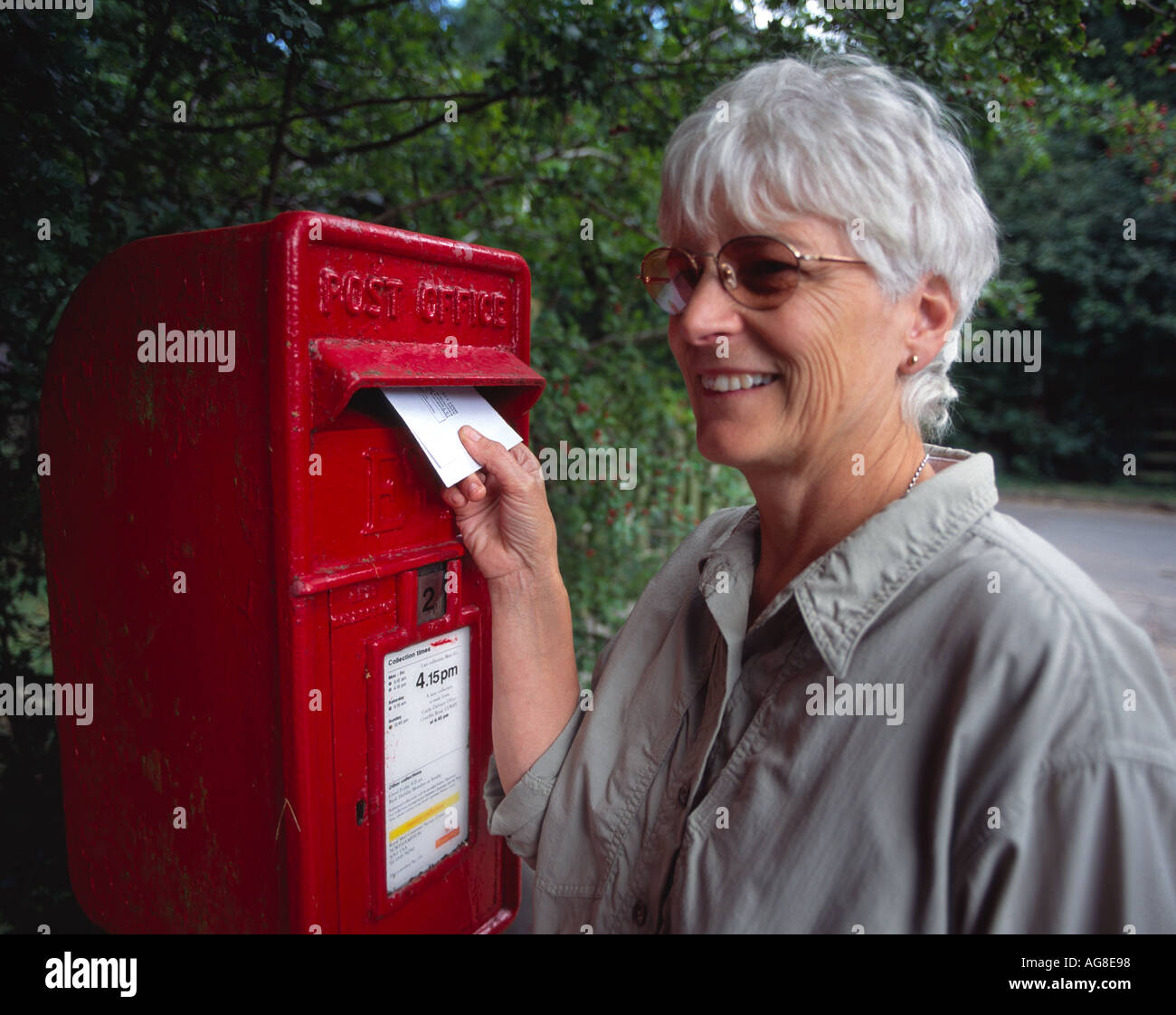 Woman posting letter in post hi-res stock photography and images - Alamy