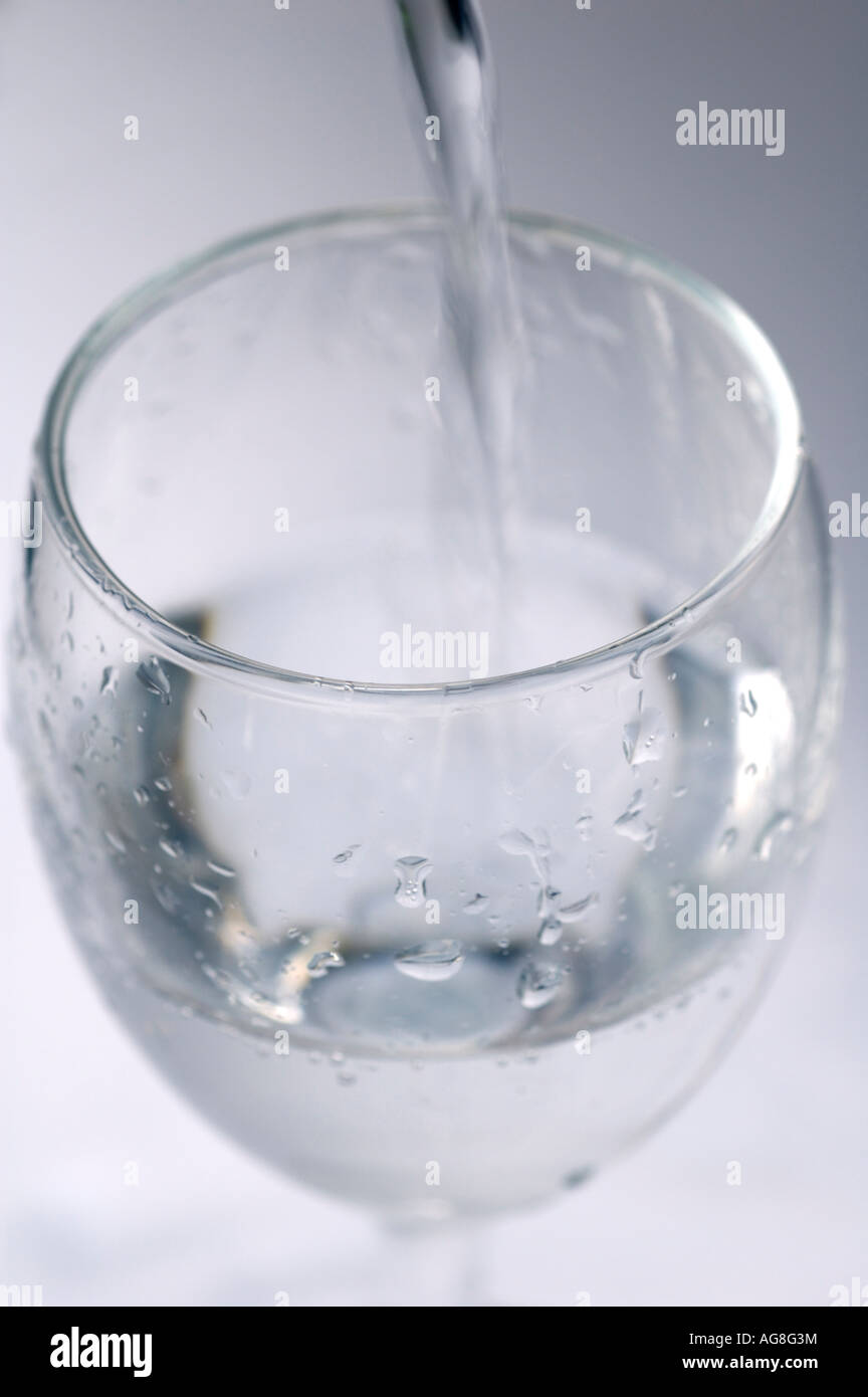 Water flowing into a glass Stock Photo - Alamy