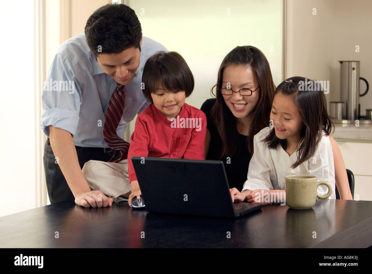 Family on Laptop Stock Photo - Alamy