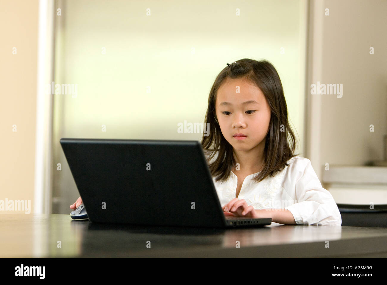 Young Girl on Laptop Stock Photo - Alamy