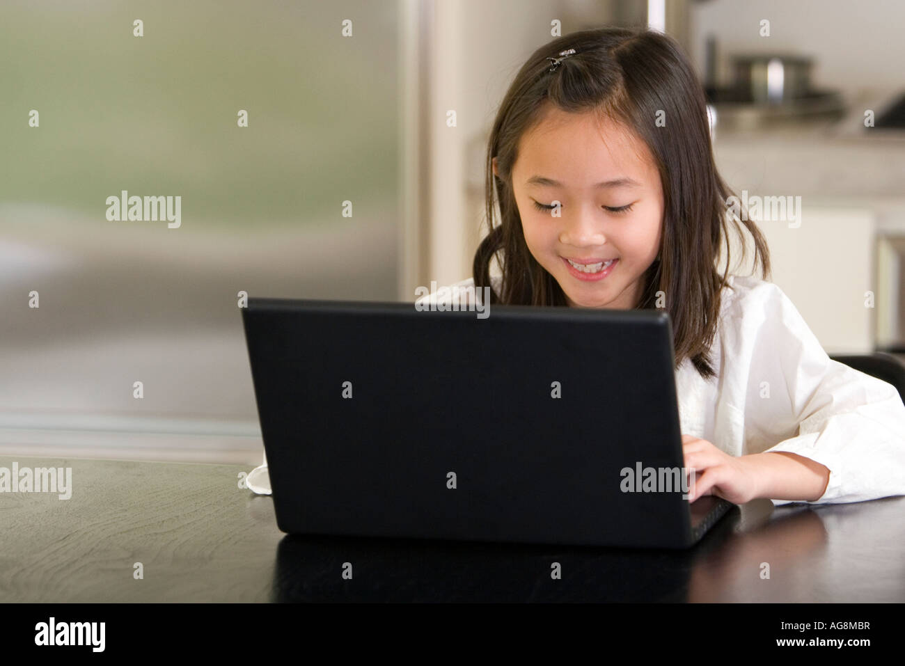 Young Girl on Laptop Stock Photo - Alamy