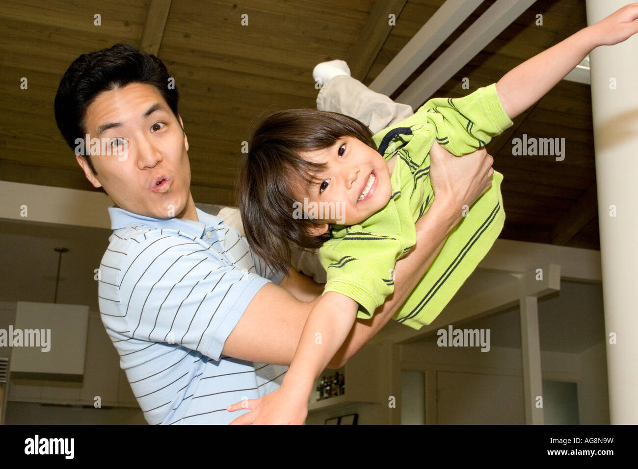 Father Holds Son Flying Stock Photo - Alamy