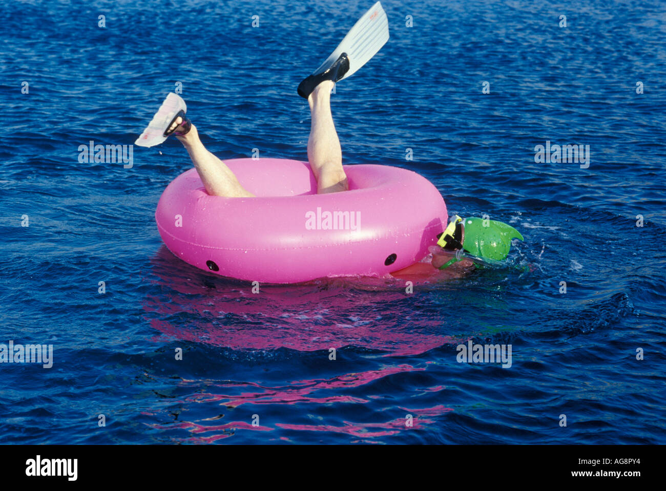 Floating tire bathing flippers playing Water sea lake Stock Photo - Alamy