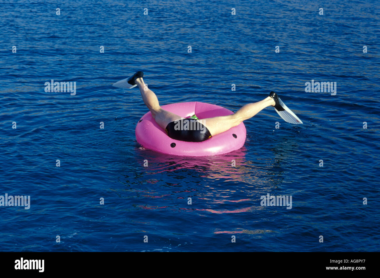Floating tire bathing flippers playing Water sea lake Stock Photo - Alamy
