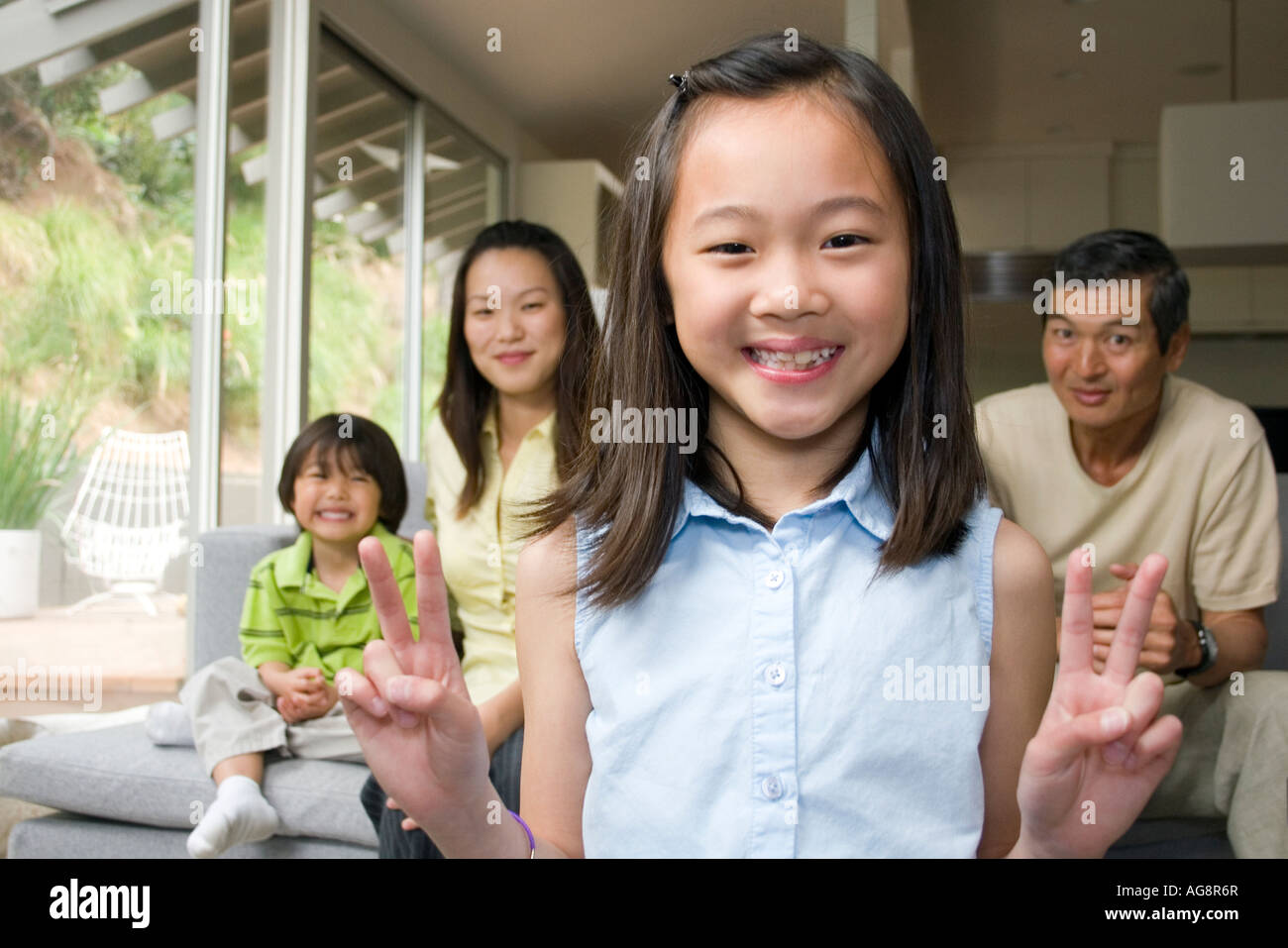 Young Girl Holding Peace Sign Stock Photo - Alamy