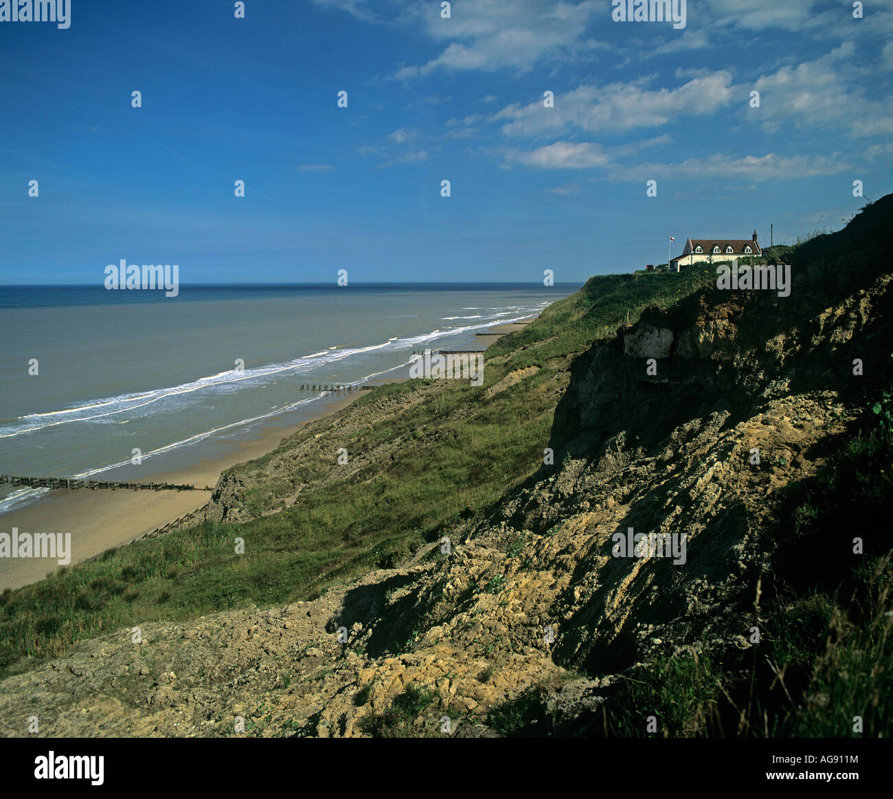 House on the edge of the crumbling cliffs at Trimmingham 3 miles East ...