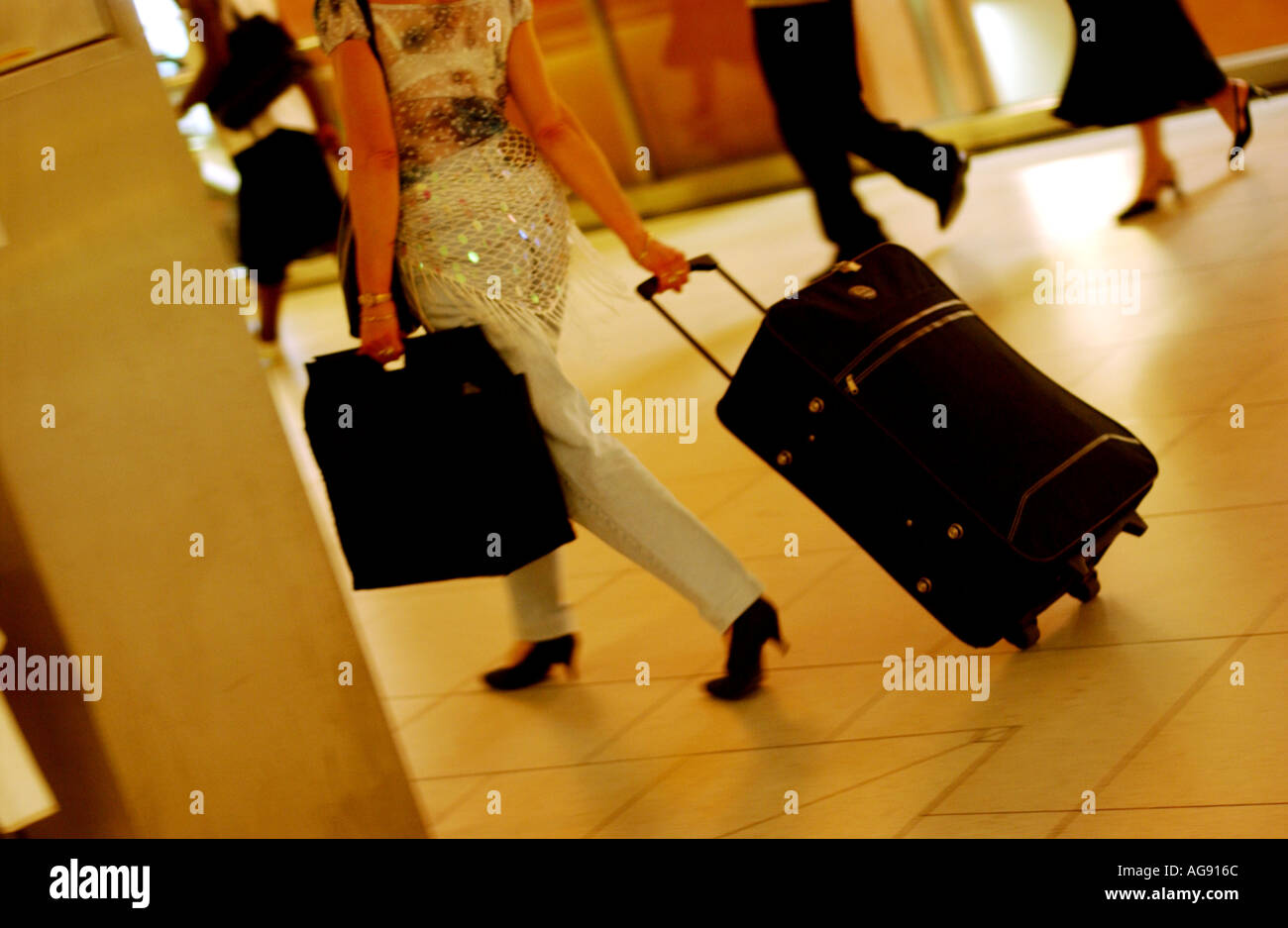 Woman pulling suitcases hi-res stock photography and images - Alamy