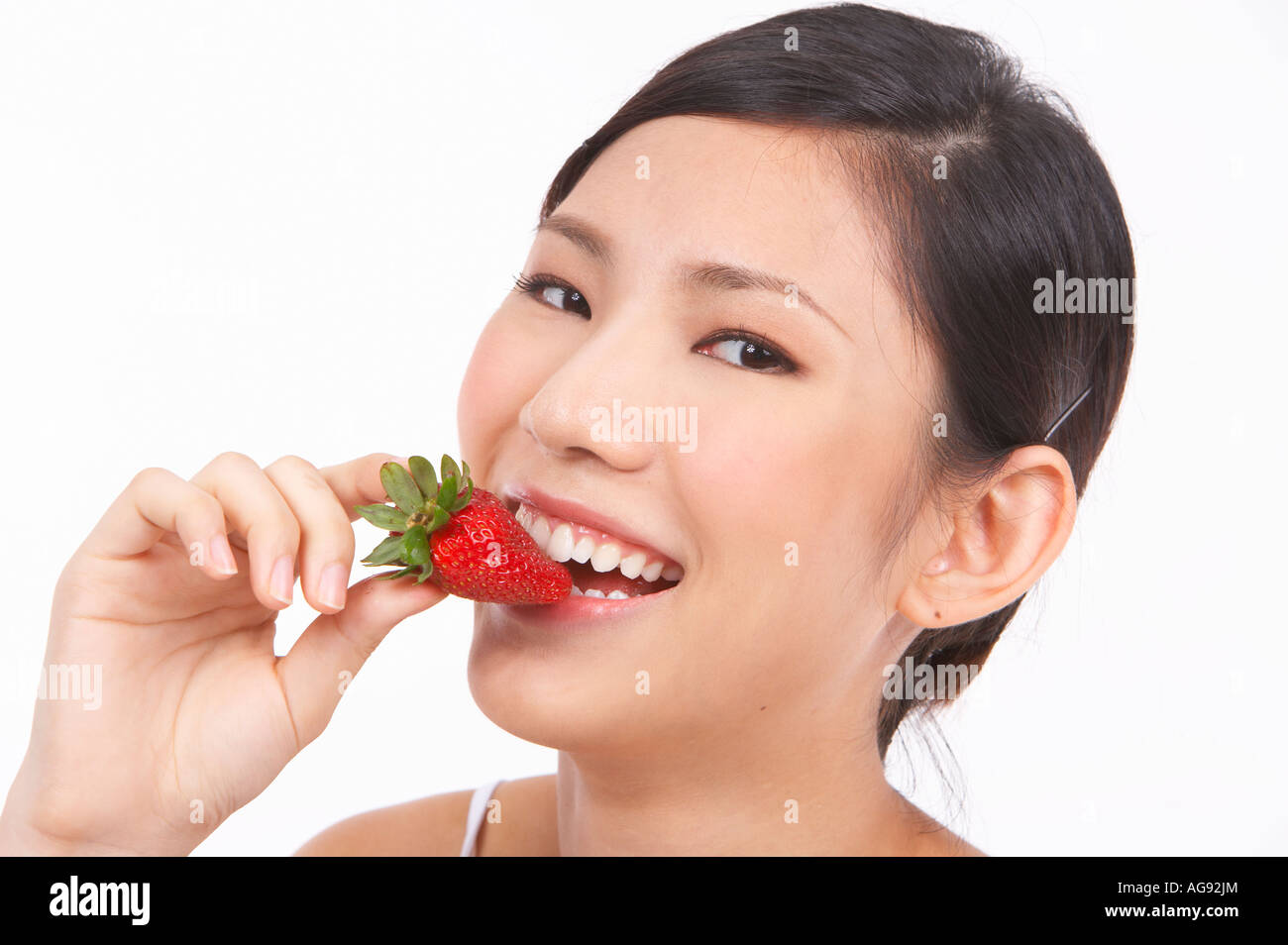 Portrait of Natural Young girl eating Strawberry Stock Photo - Alamy