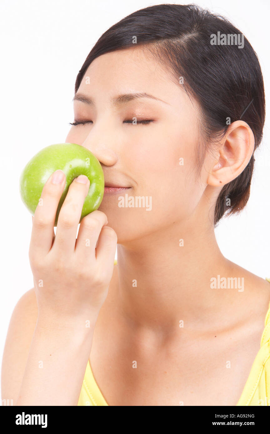 Portrait of Natural Young girl smelling Apple Stock Photo - Alamy