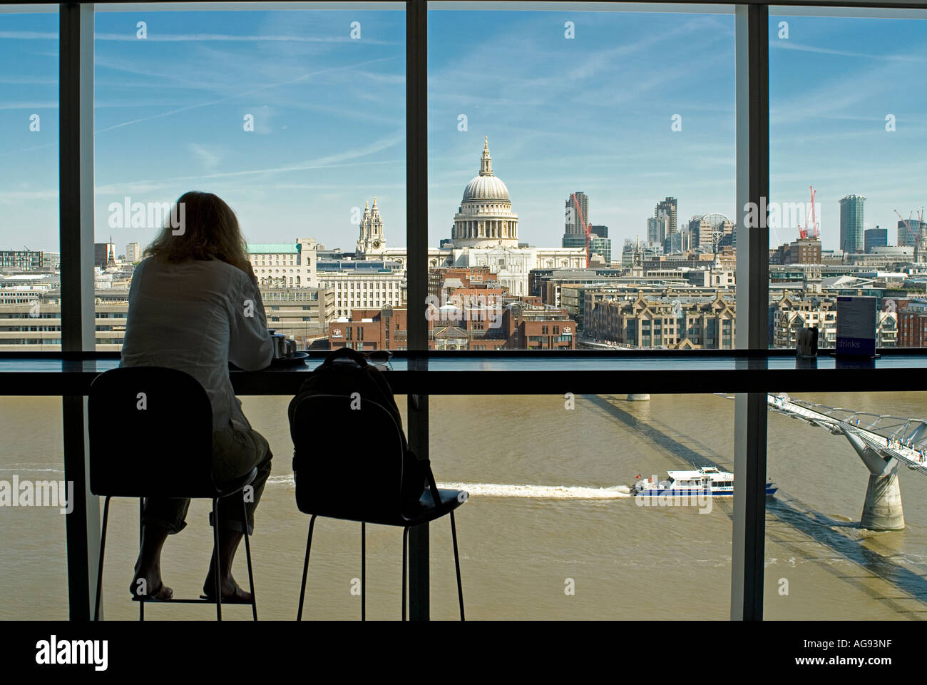 Silhouetted shapes of a visitor seated at a window overlooking the ...