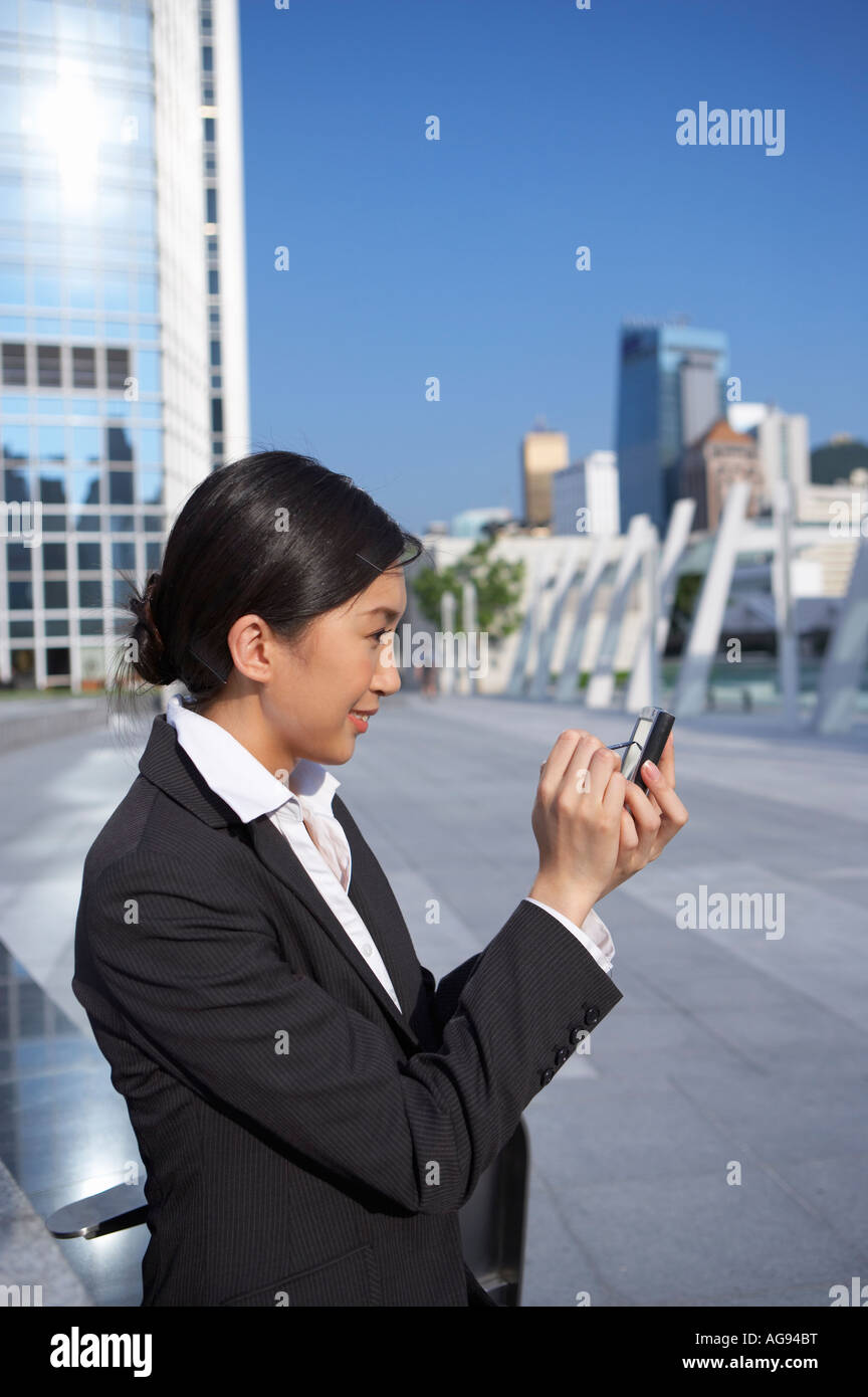 Young Businesswoman using Personal Digital Assistant, Side View Stock ...