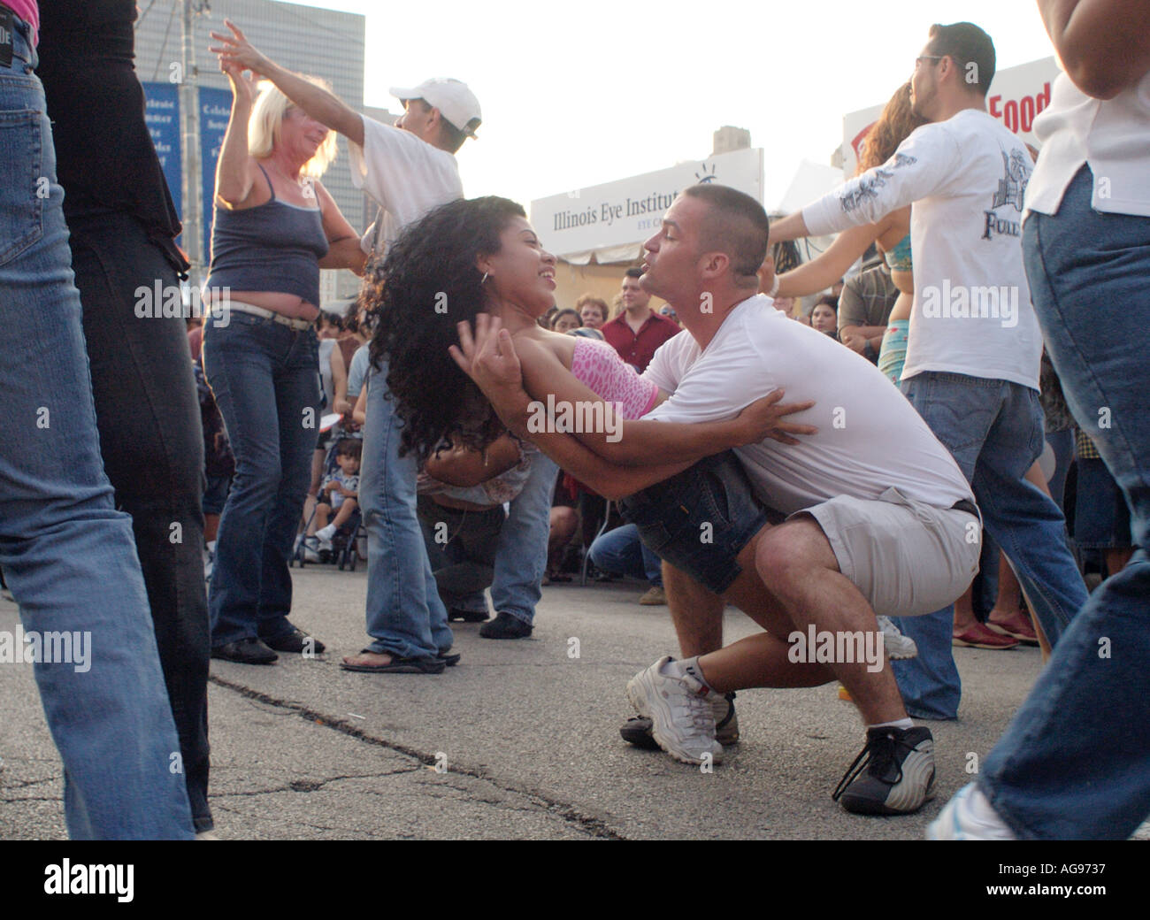 Two festival dancers doing an impromptu tango dance in the streets ...