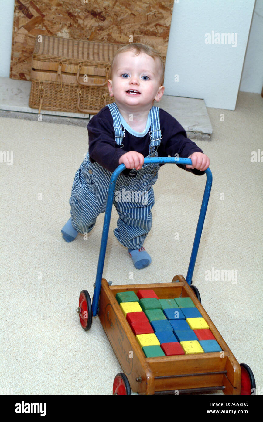 Little Boy Learns to Walk with Babywalker Stock Photo - Alamy