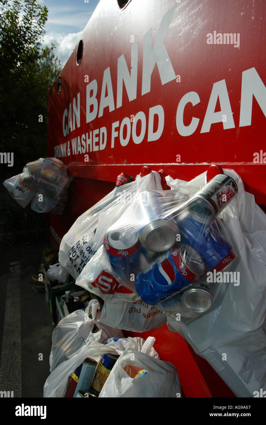 Overflowing can recycling bank Stock Photo - Alamy