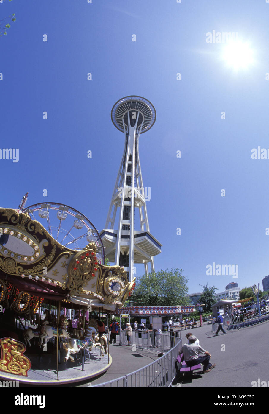 Looking up at Seattle Space Needle above a merry go round in the Fun ...