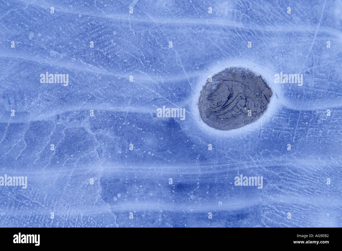 Ice pattern around rock Stock Photo - Alamy