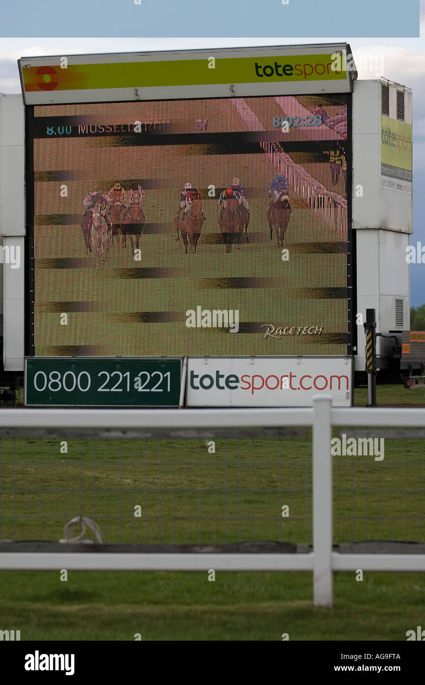 Large Tscreen at race course providing coverage of racetrack action ...